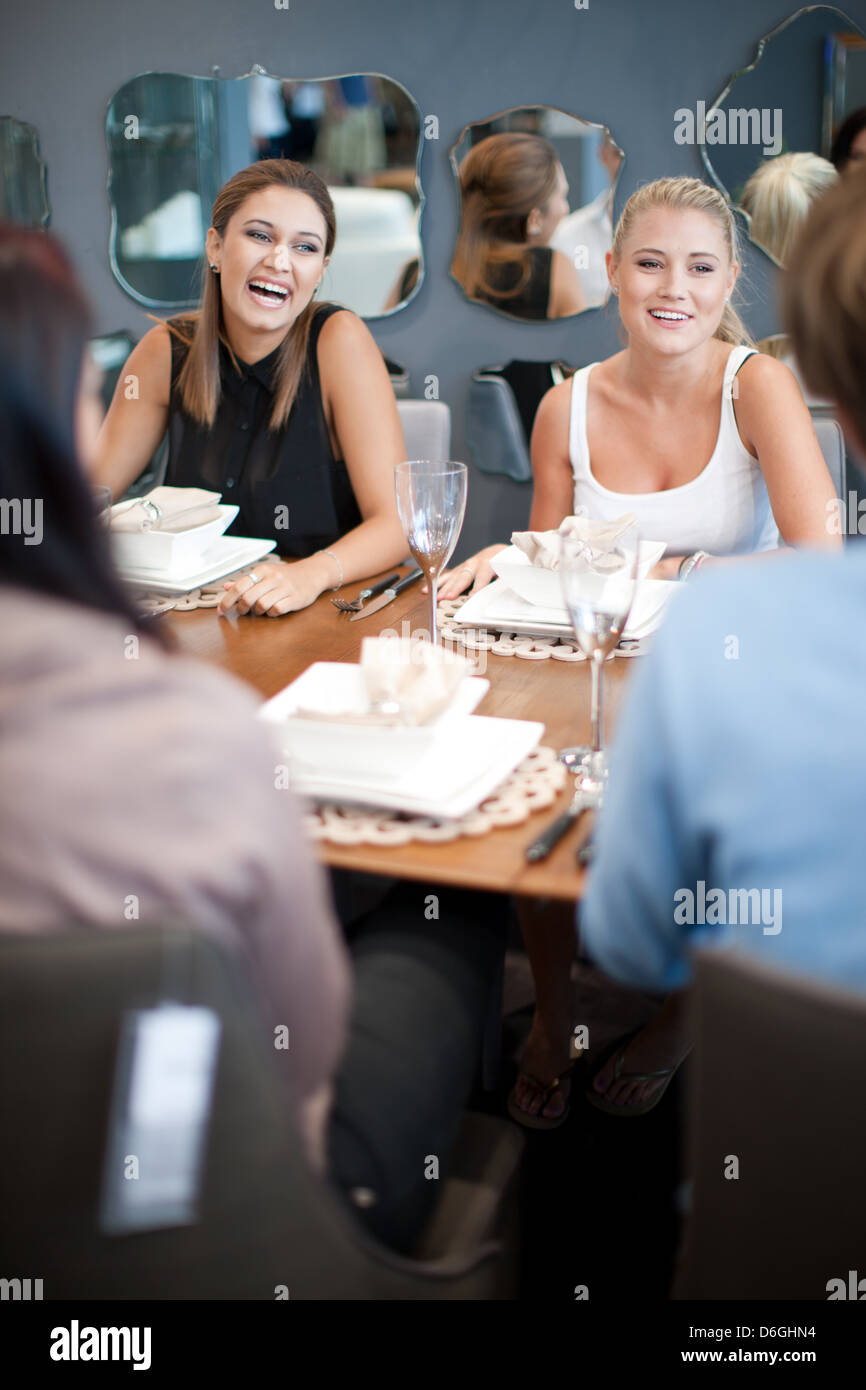 Friends talking at dinner table Stock Photo - Alamy