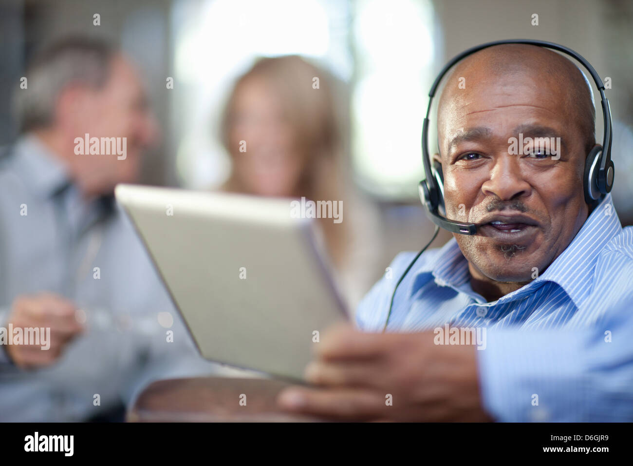 Older man wearing headset Stock Photo - Alamy