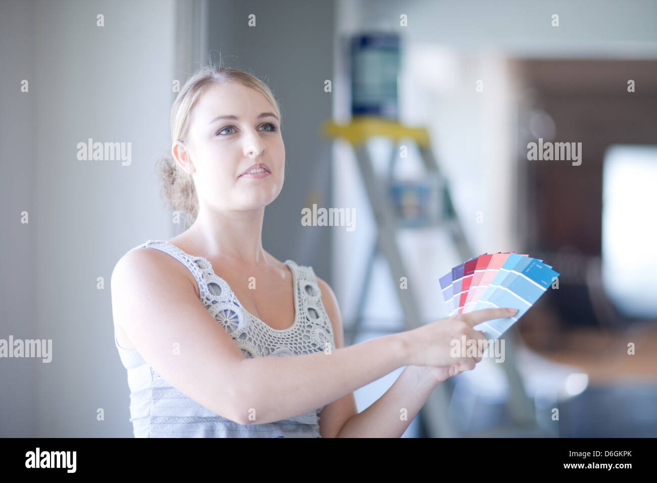 Woman picking paint swatches in home Stock Photo - Alamy