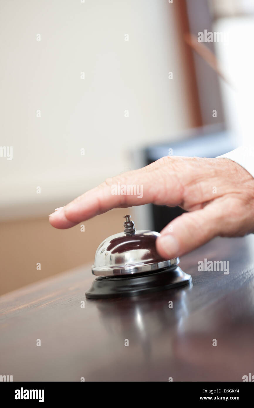 Man ringing bell in hotel lobby Stock Photo - Alamy