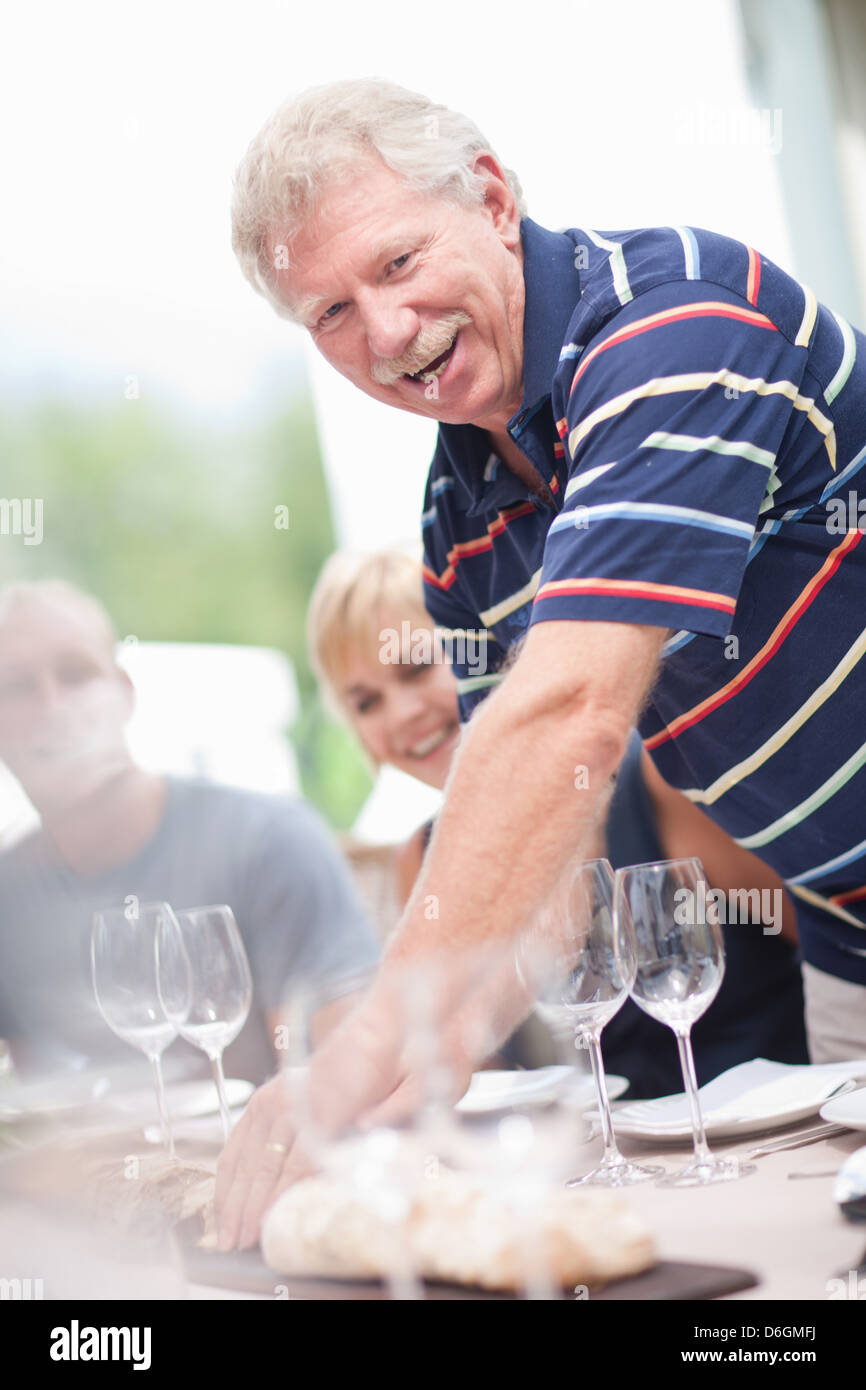 Man setting table outdoors Stock Photo - Alamy