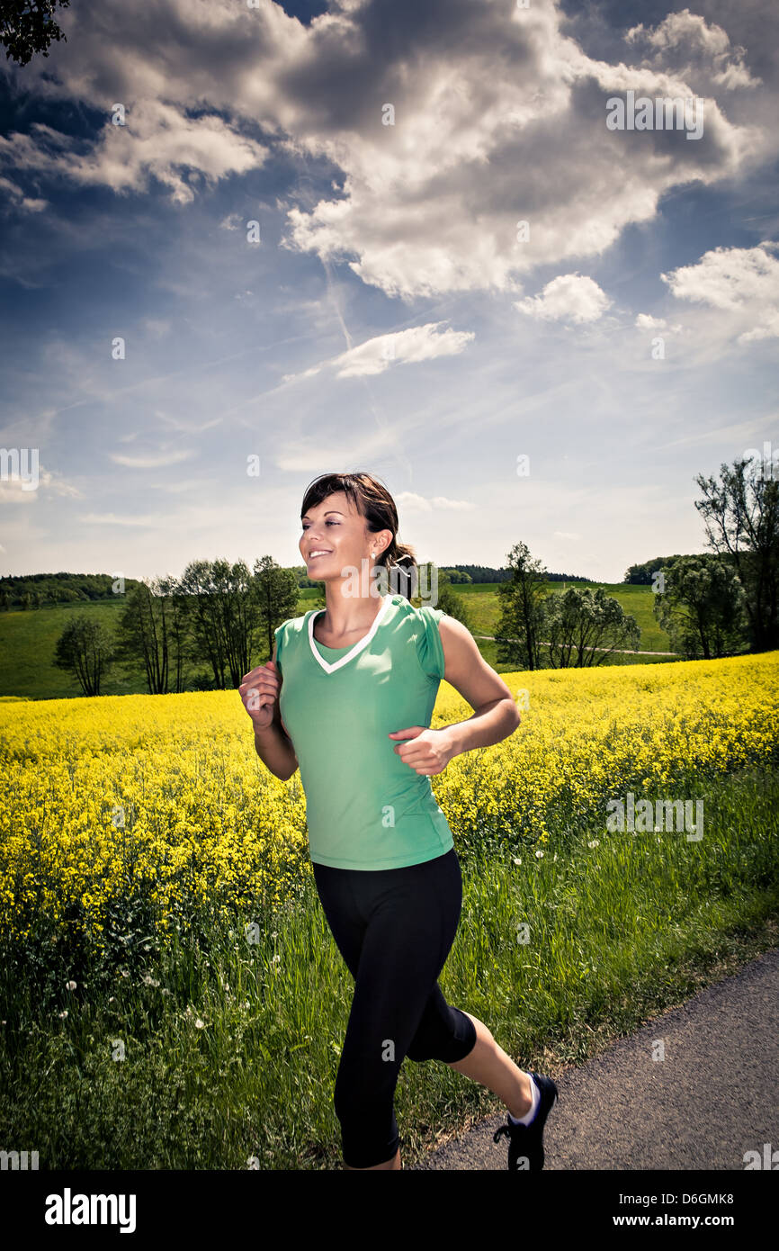 A woman jogging in front of cross country Stock Photo - Alamy
