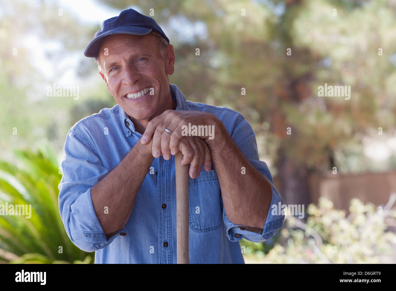 Older man gardening outdoors Stock Photo - Alamy