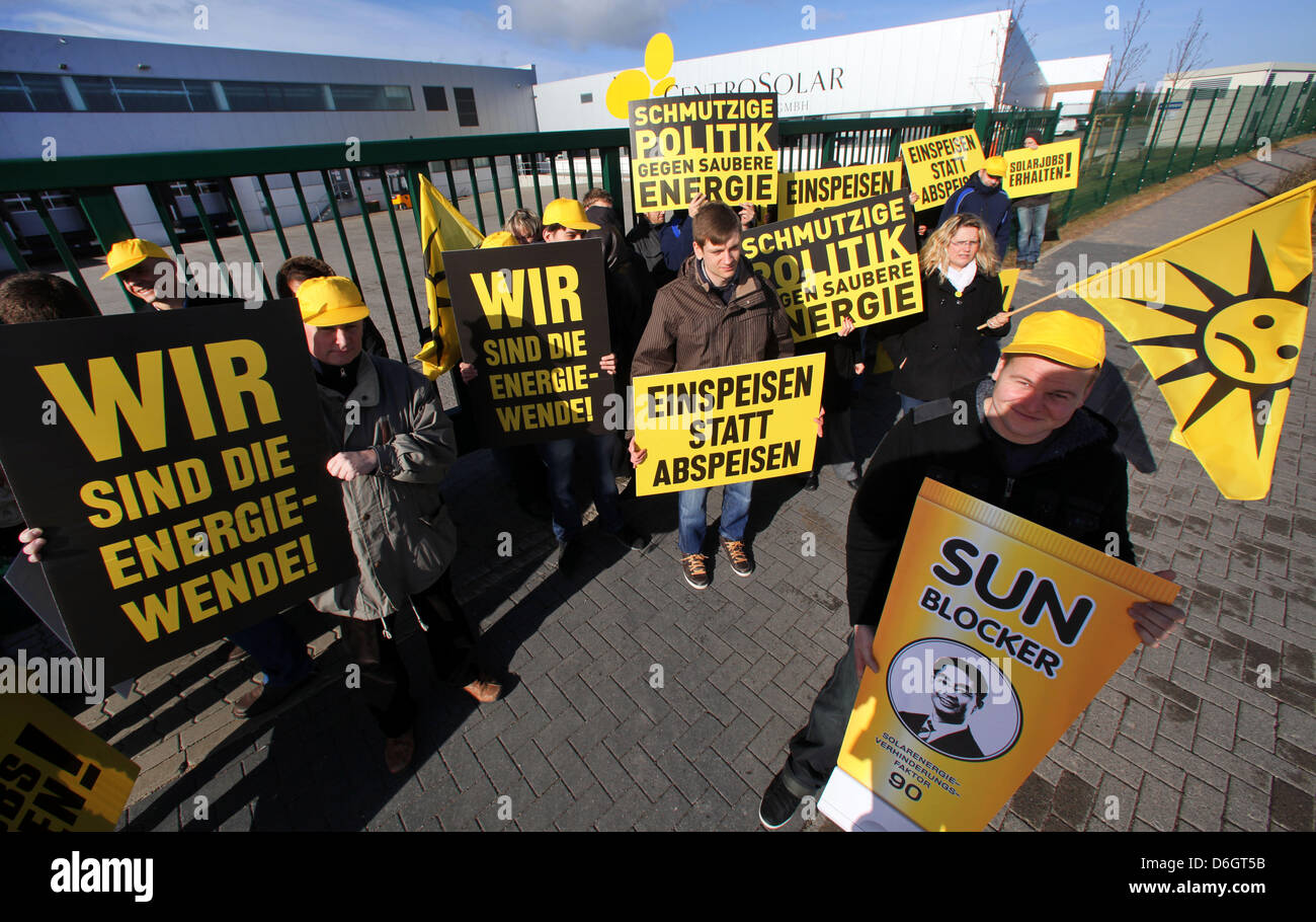 Pprotesters hold flags and posters during a protest by employees of the ...