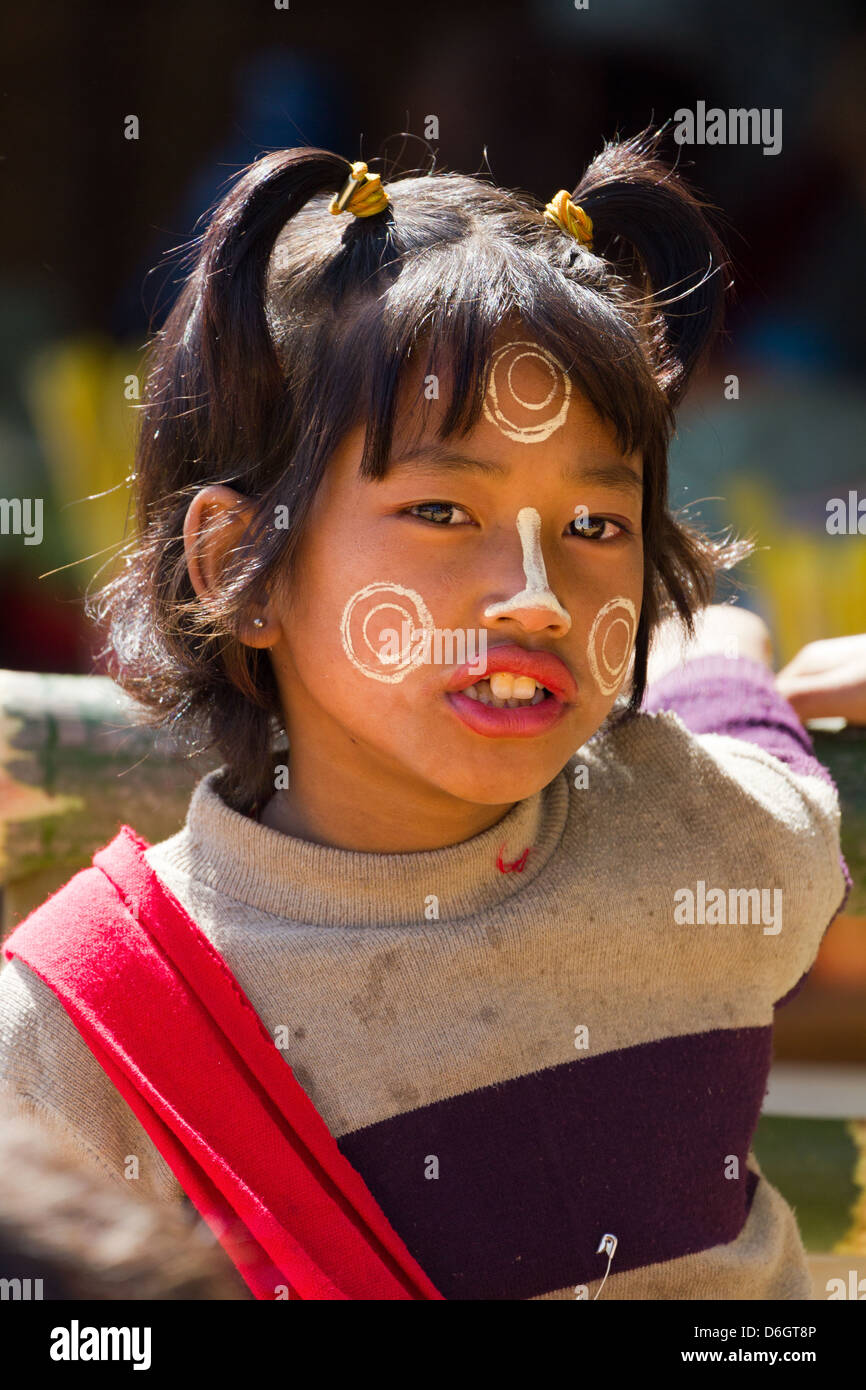 Cheeky little girl with Thanaka face decorations in Inn Thein Village ...