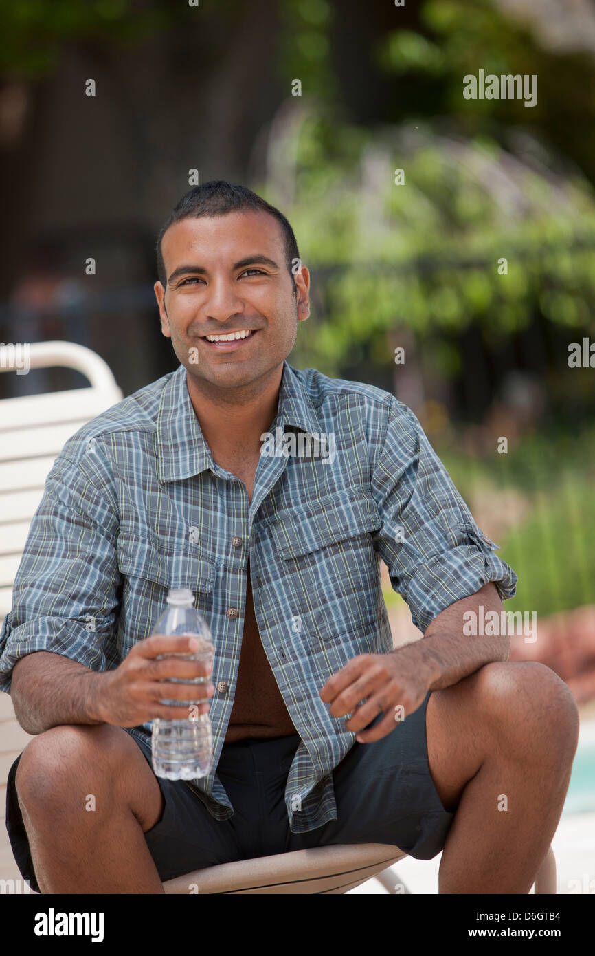 Man drinking water in swimming pool Stock Photo - Alamy
