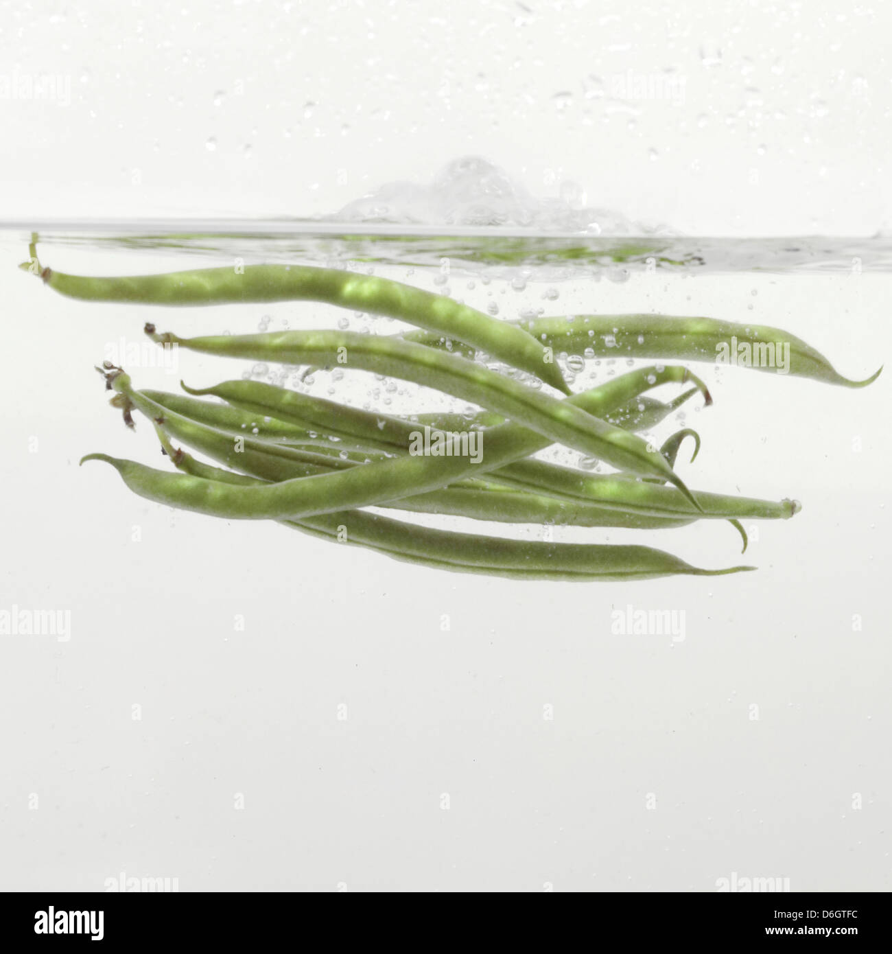 Green beans splash into water Stock Photo - Alamy