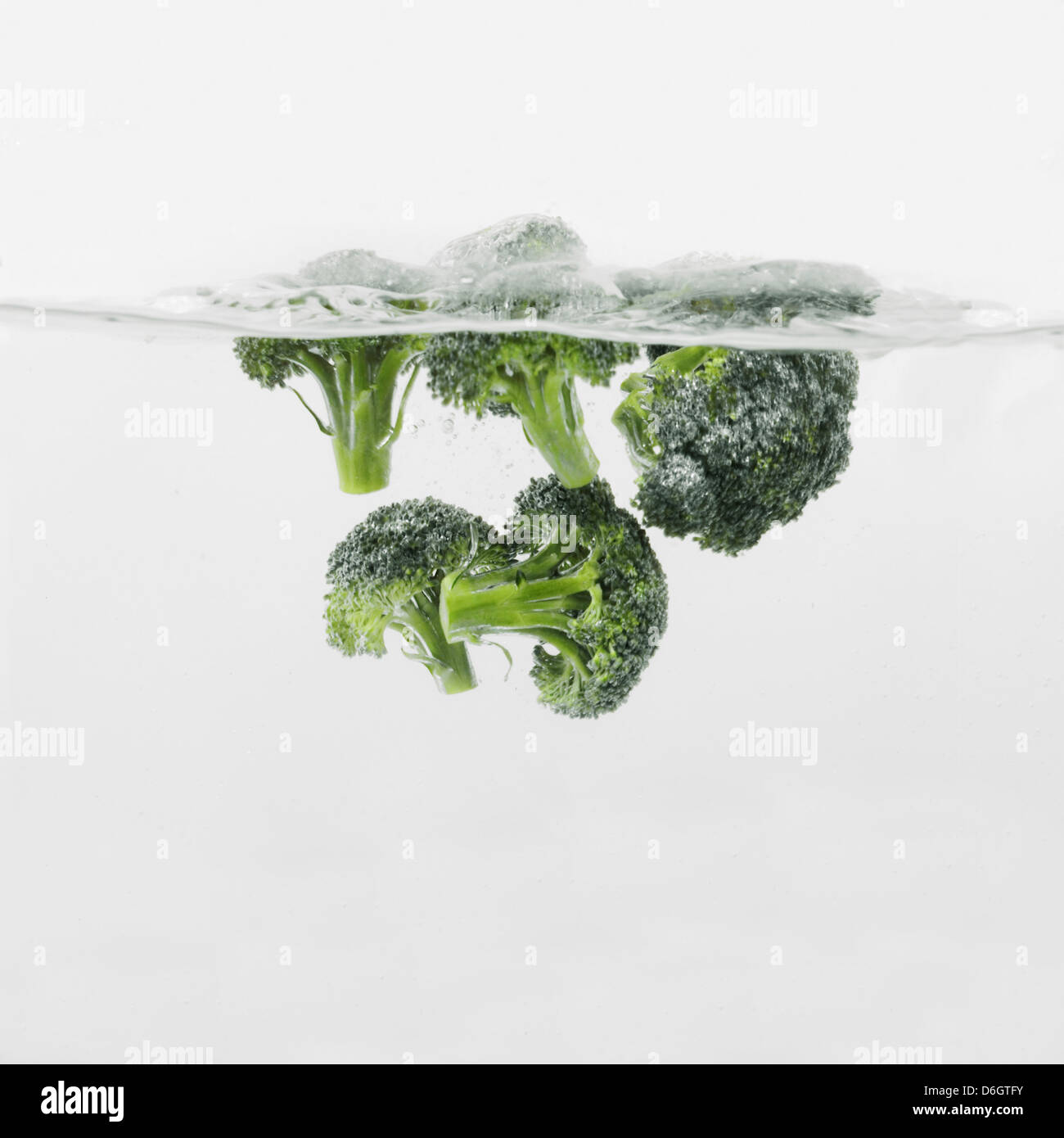 Broccoli splashing into water Stock Photo - Alamy