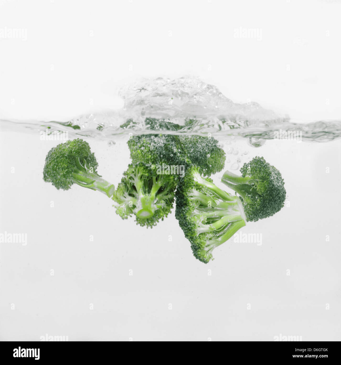 Broccoli splashing into water Stock Photo - Alamy