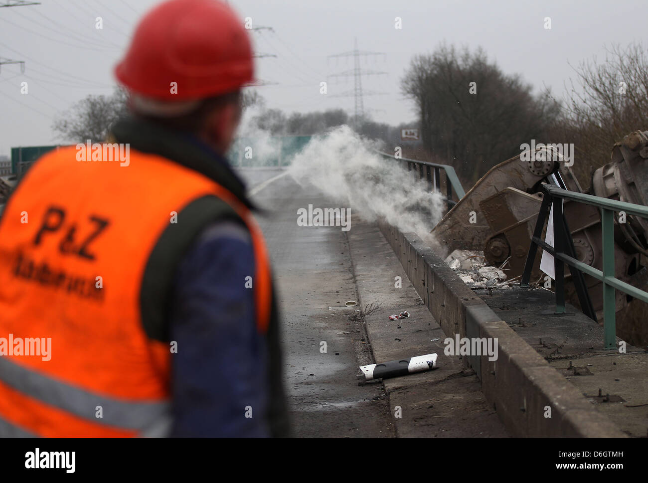 An excavator starts to demolish a bridge at the Autobahn 57 severely ...