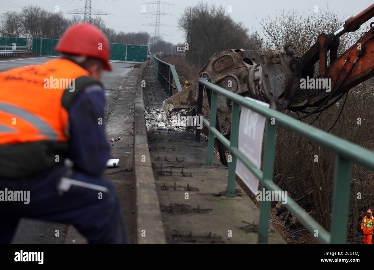 An excavator starts to demolish a bridge at the Autobahn 57 severely ...