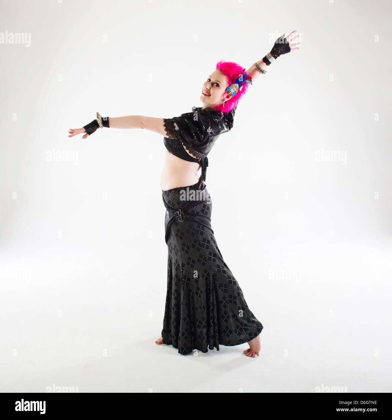 Pink haired belly dancer on white background in a studio shot. (CTK ...