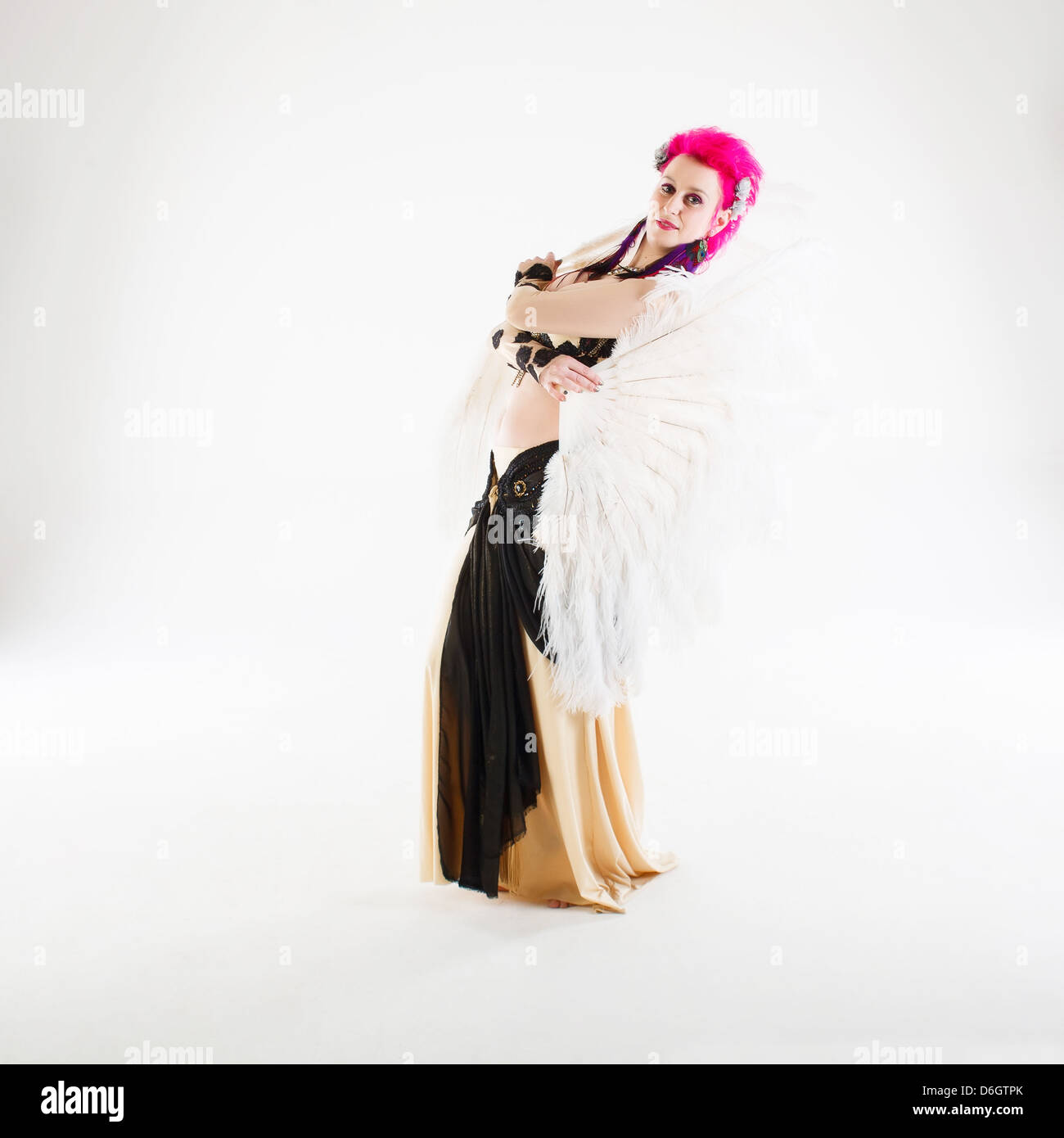 Pink haired belly dancer on white background in a studio shot. (CTK ...