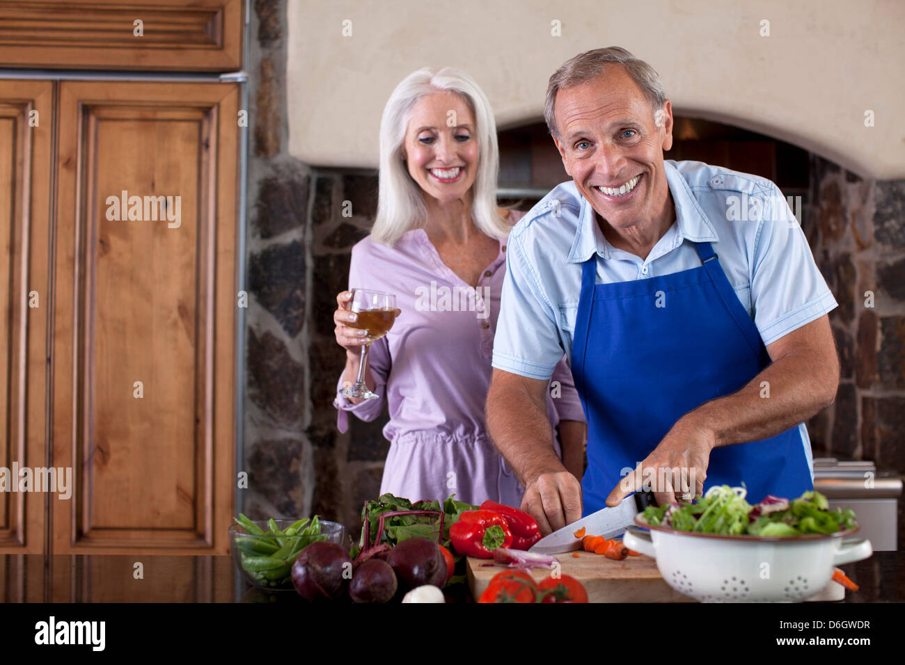 Older couple cooking in kitchen Stock Photo - Alamy