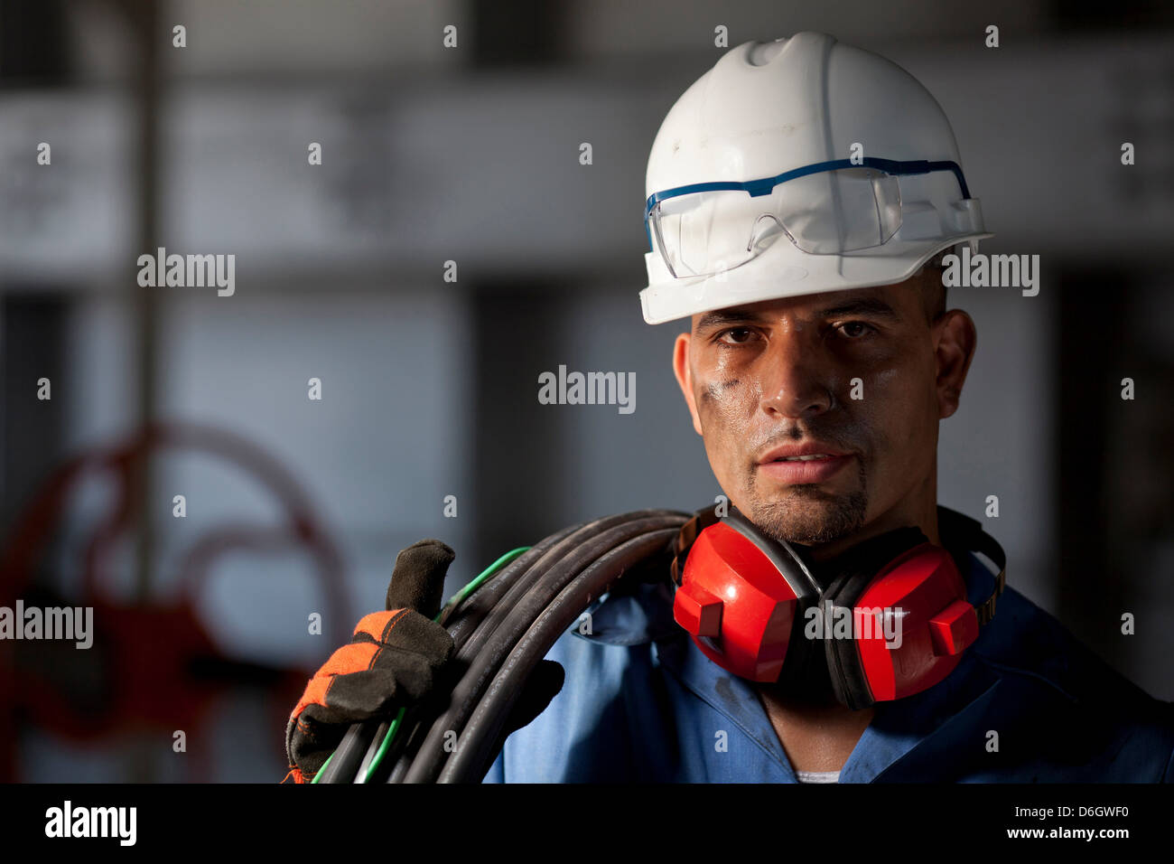 Industrial worker with wires in plant Stock Photo - Alamy