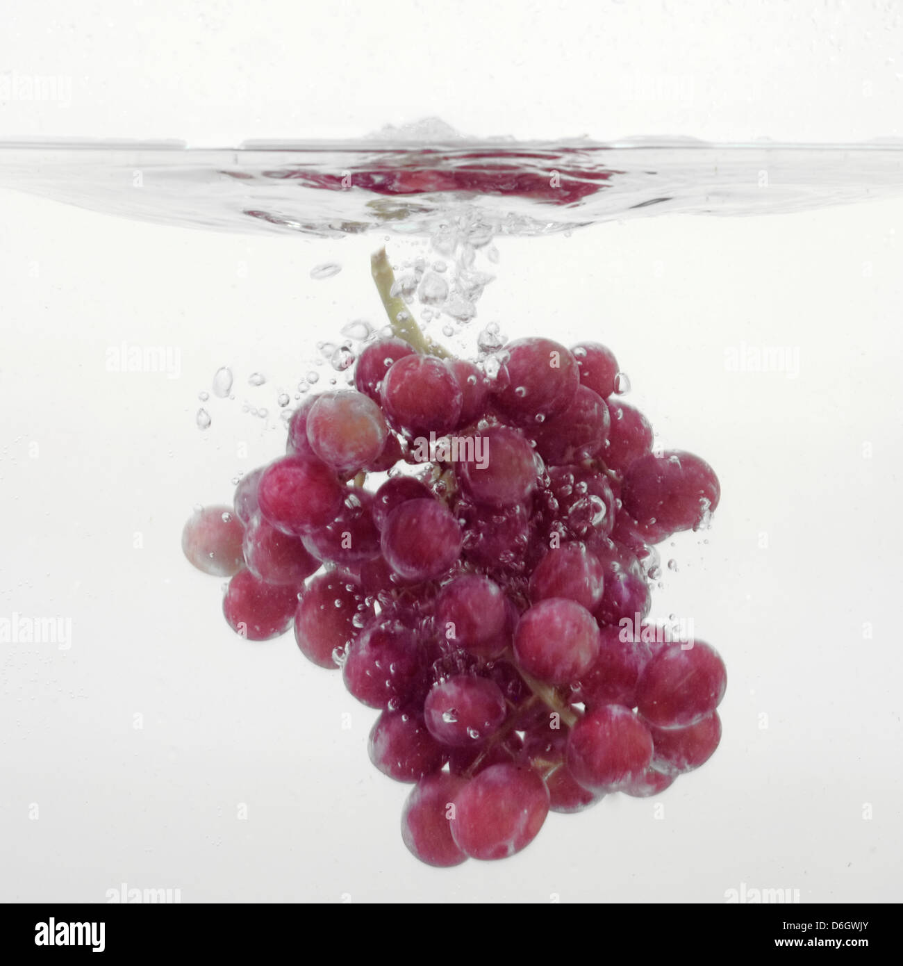Bunch of Grapes splashing into water Stock Photo - Alamy