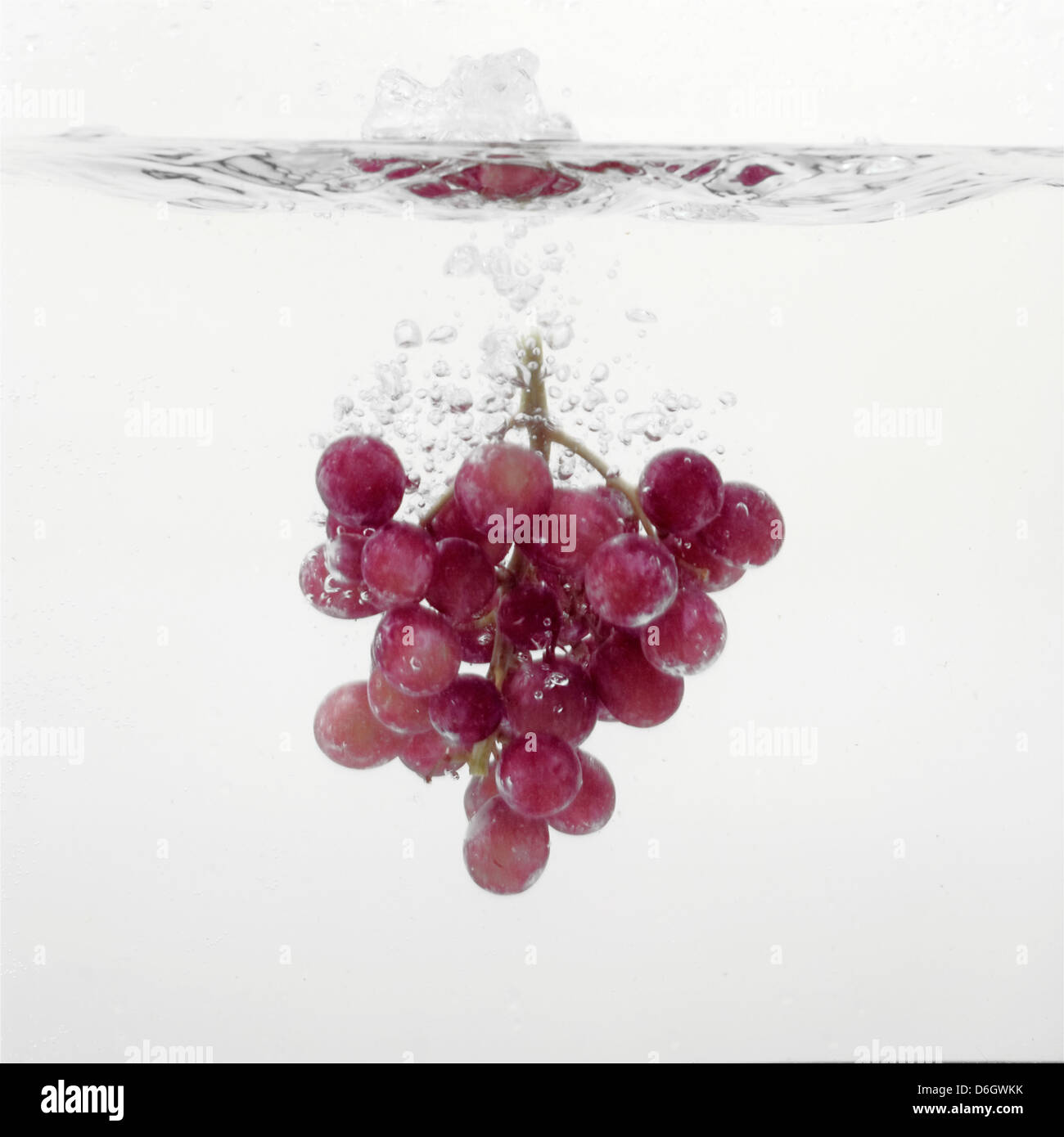 Bunch of Grapes splashing into water Stock Photo - Alamy