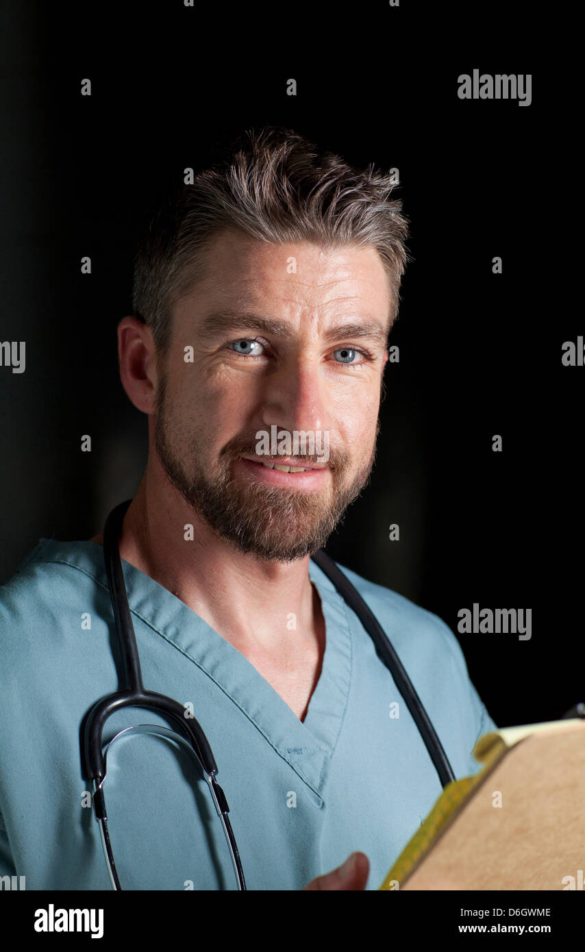 Doctor reading medical chart Stock Photo - Alamy