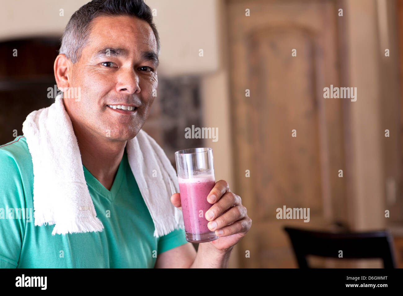 Man drinking smoothie in kitchen Stock Photo - Alamy