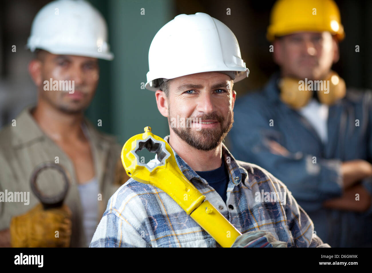 Industrial worker smiling in plant Stock Photo - Alamy