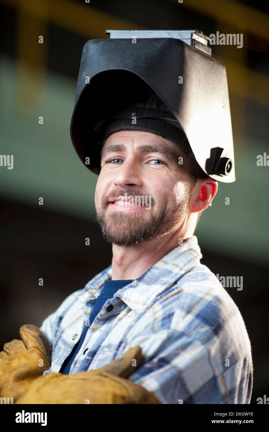 Industrial worker smiling in plant Stock Photo - Alamy