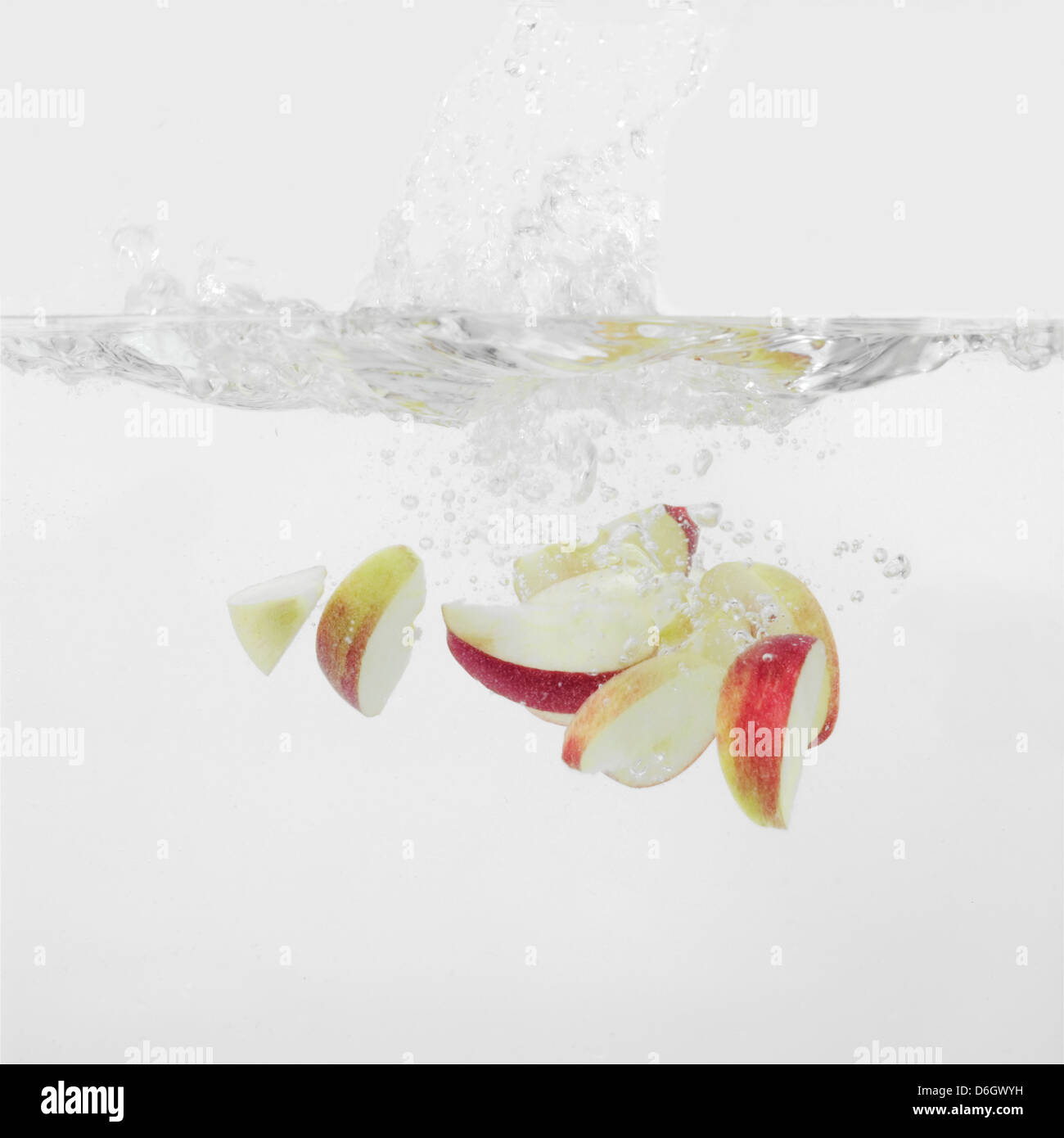 Apple Slices splashing into water Stock Photo - Alamy