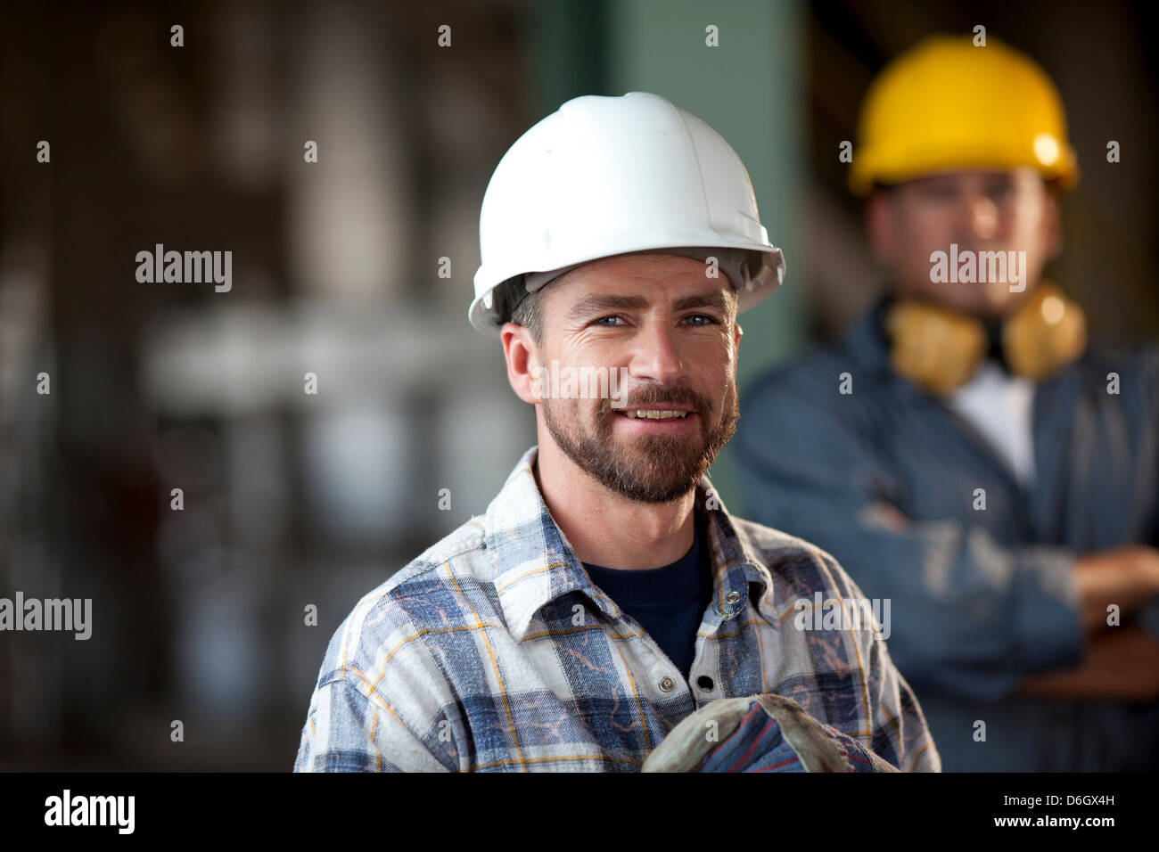 Industrial worker smiling in plant Stock Photo - Alamy