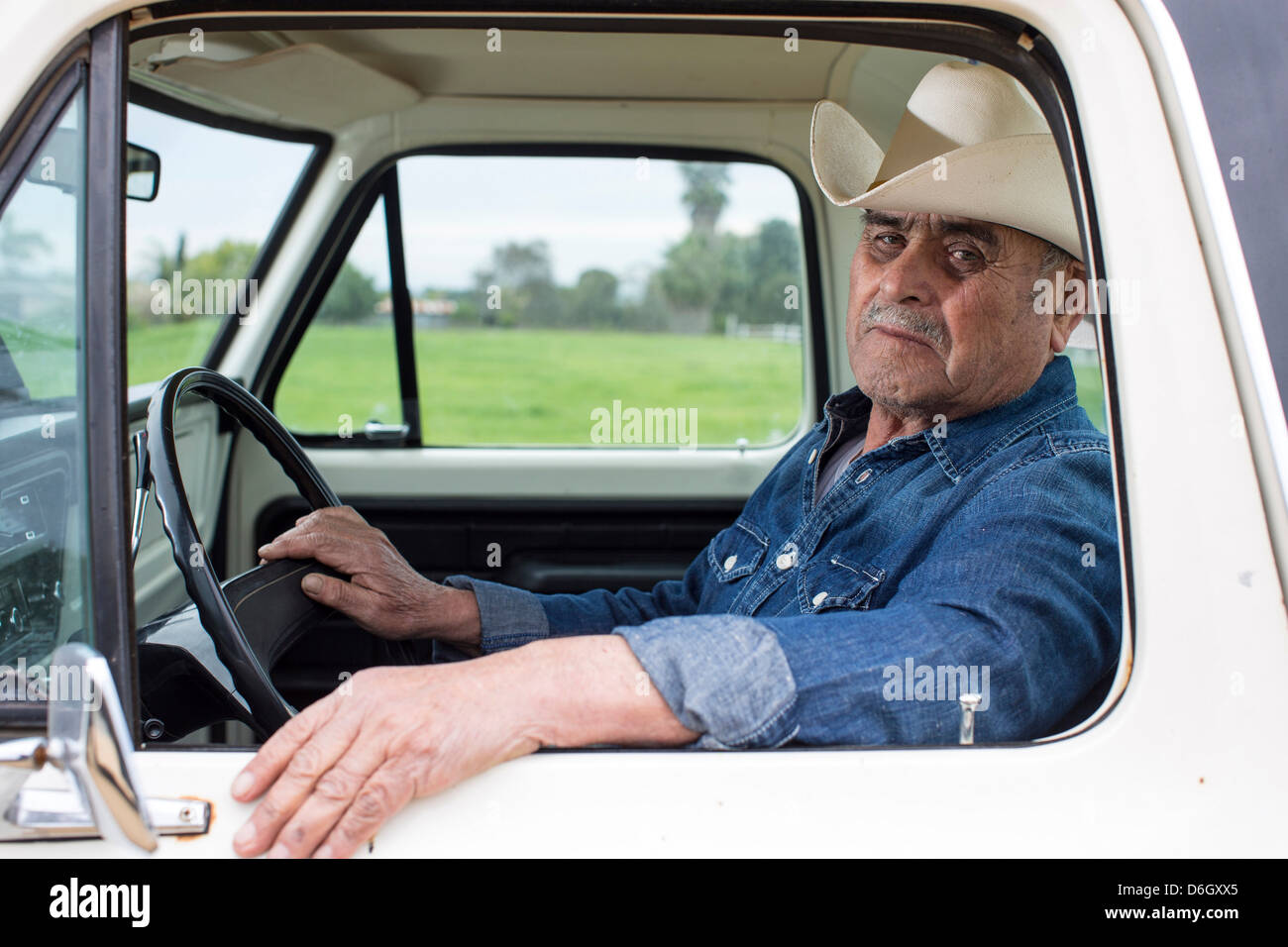 Farmer driving truck Stock Photo - Alamy