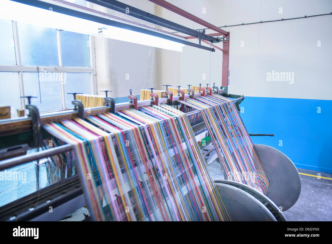 Colorful yarn on loom in textile mill Stock Photo - Alamy