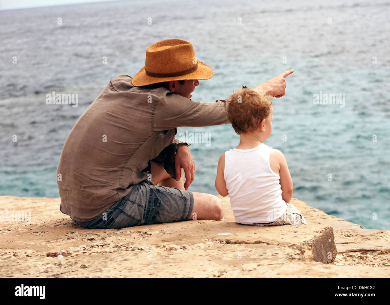 Father and son overlooking ocean Stock Photo - Alamy