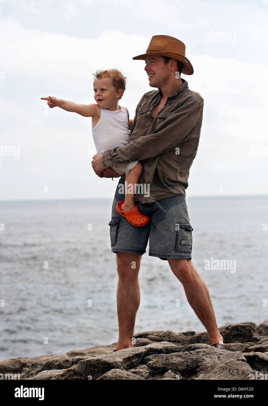 Father and son overlooking ocean Stock Photo - Alamy