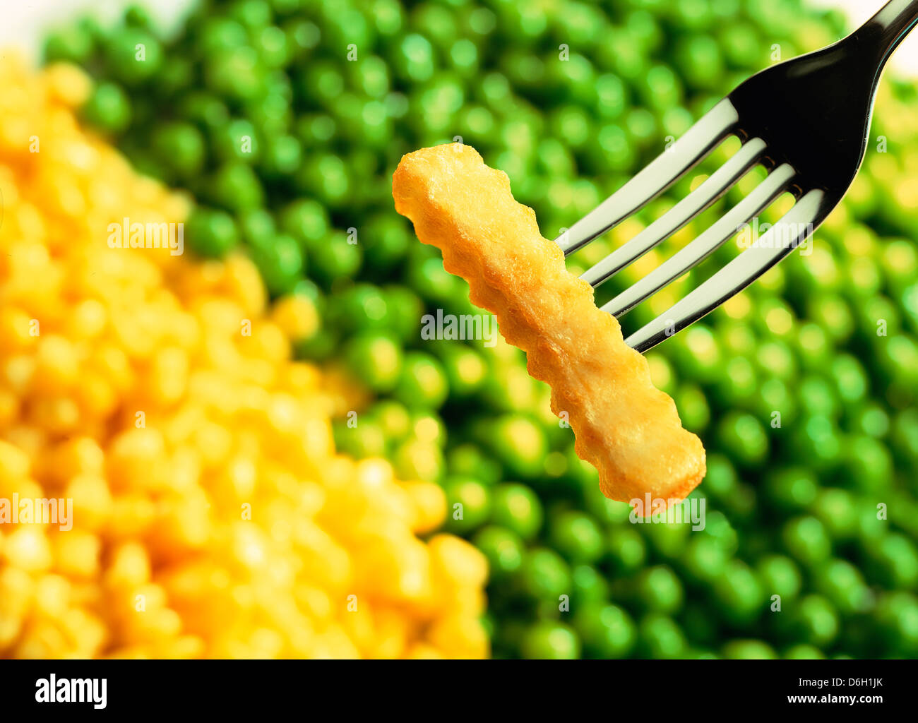 Chip on fork with peas Stock Photo - Alamy
