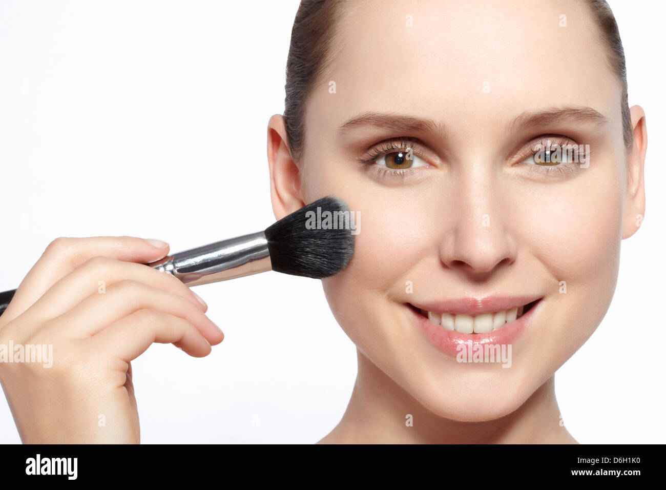 Smiling woman applying makeup Stock Photo - Alamy