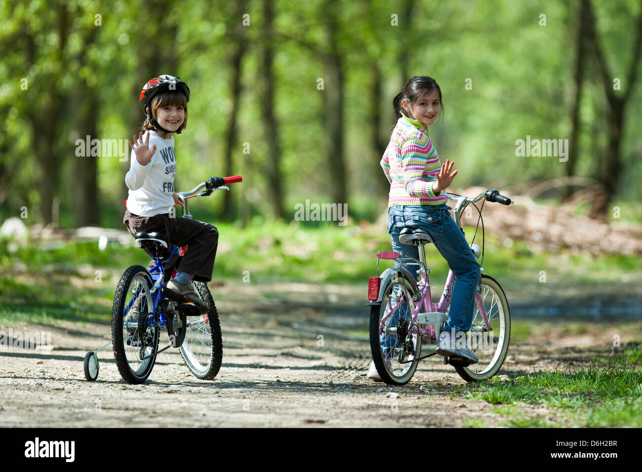 Girls riding bicycles in park Stock Photo - Alamy
