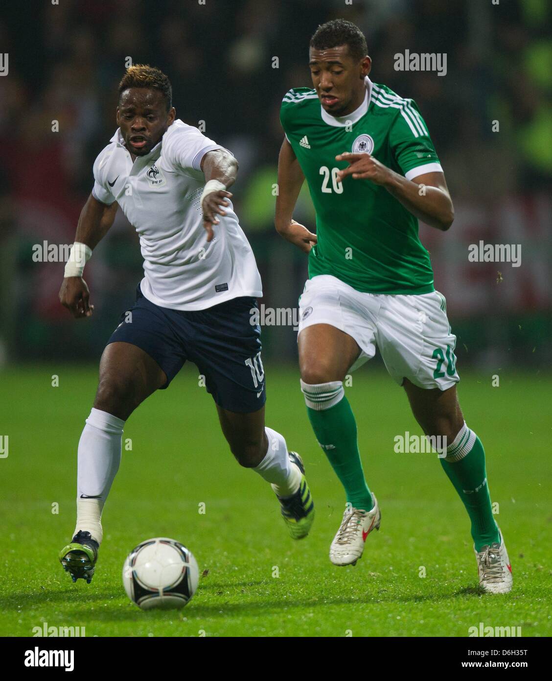 Germany's Jerome Boateng (R) and Louis Saha of France fight for the ...