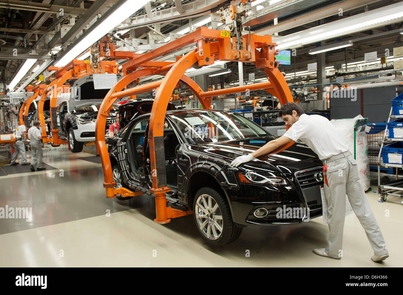 An employee works on an Audi A4 on the production line at the Audi ...