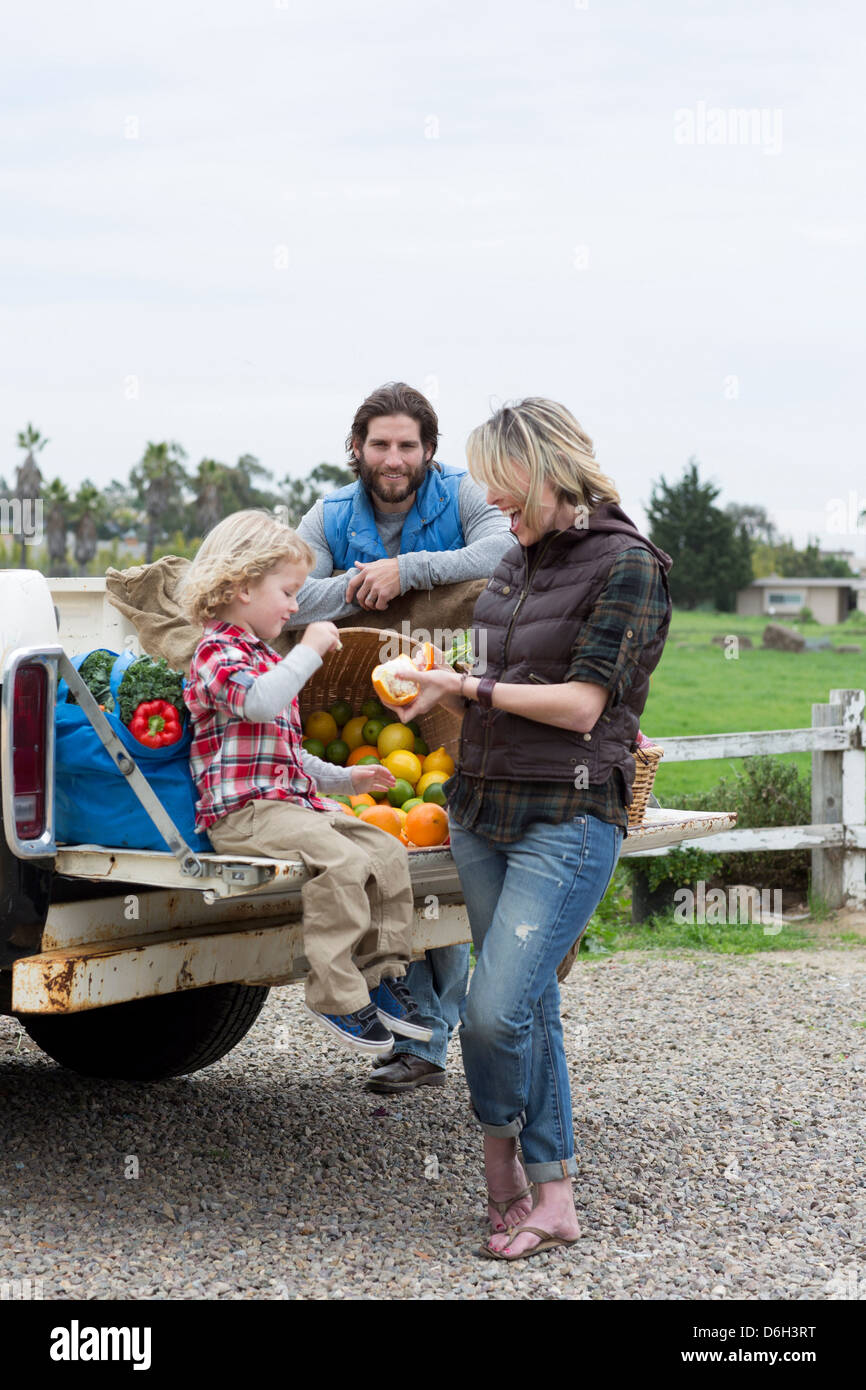Family with produce in truck bed Stock Photo - Alamy