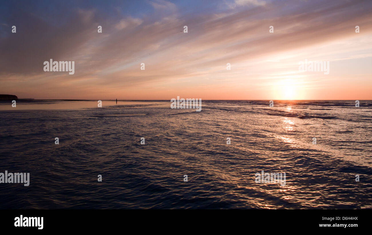Distant figure on beach, sunset, over sea, Normandy, France Stock Photo ...