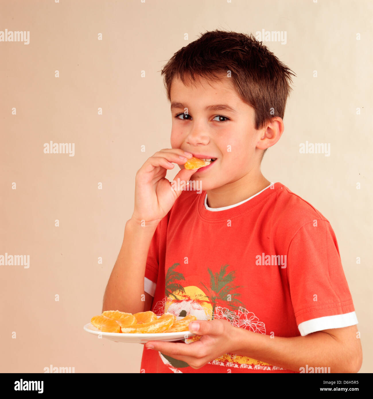 Child eating orange Stock Photo - Alamy