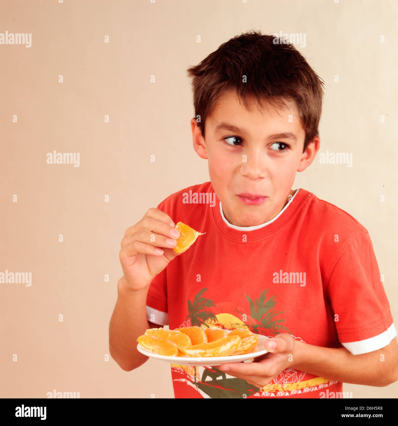 Child eating orange Stock Photo - Alamy