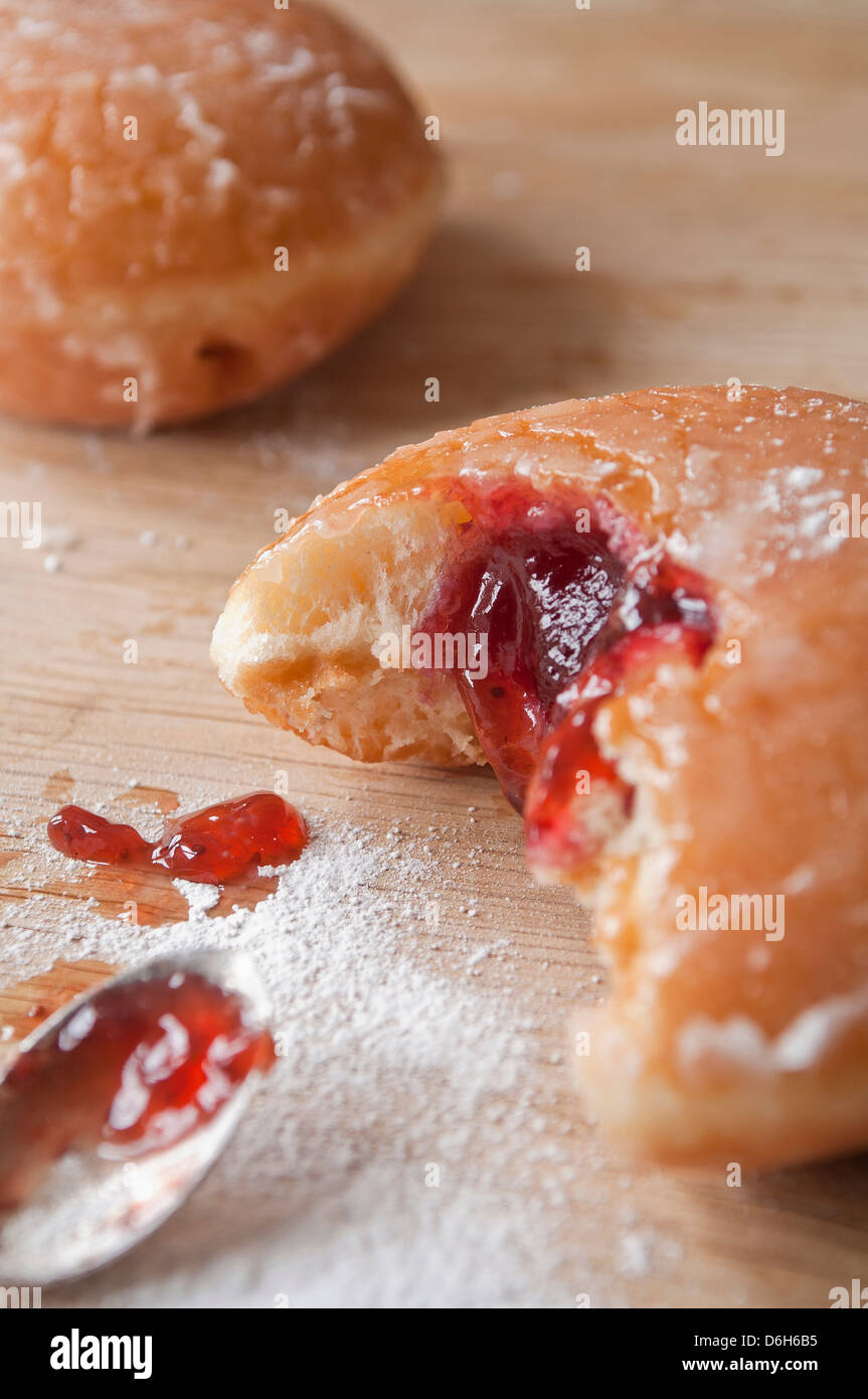 Jam doughnut on table Stock Photo - Alamy