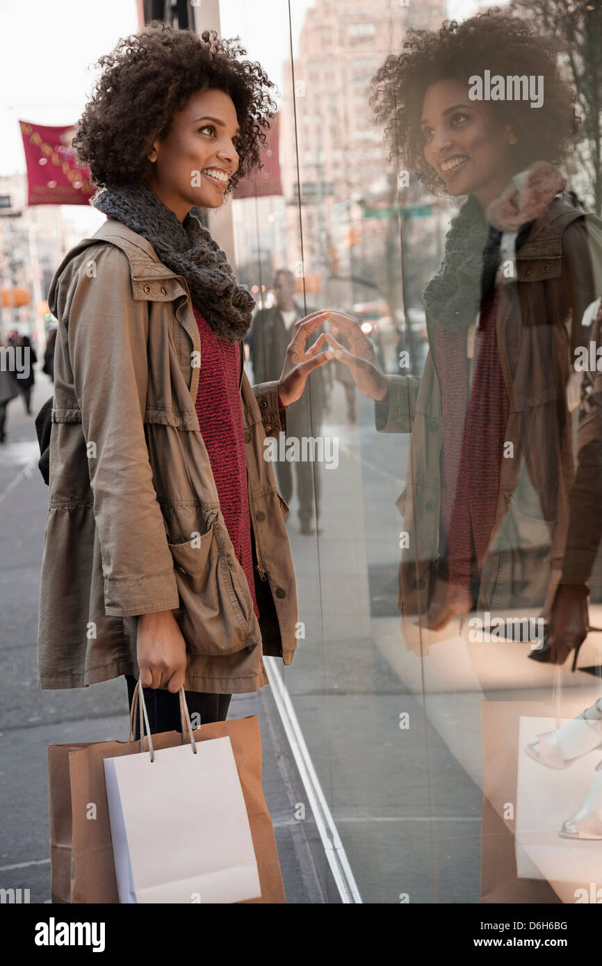 Woman window shopping on city street Stock Photo - Alamy