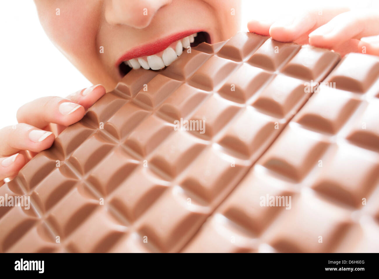Woman eating chocolate Stock Photo - Alamy