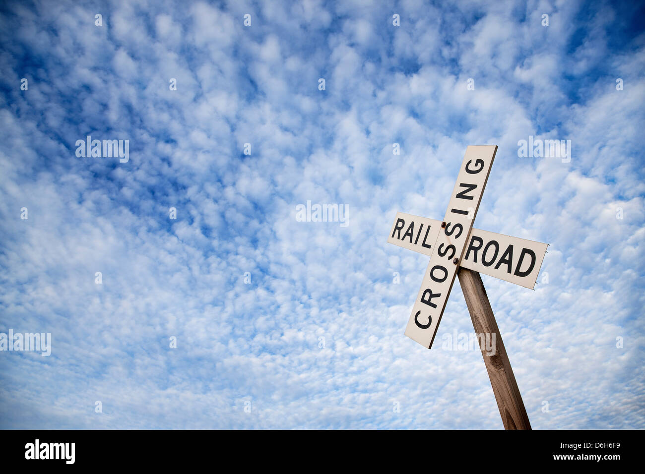 'Railroad crossing' sign under blue sky Stock Photo - Alamy