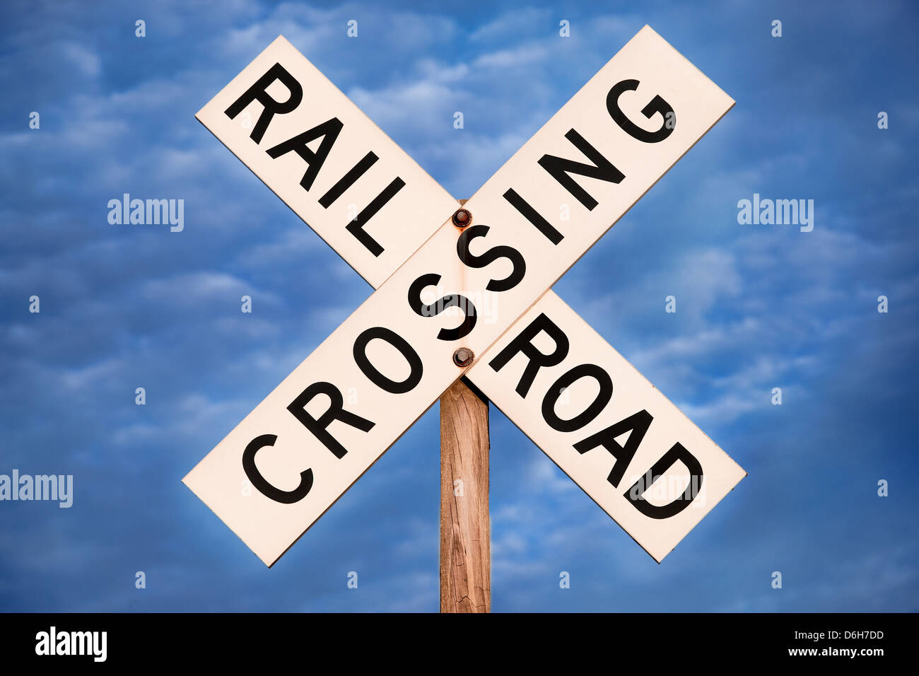 'Railroad crossing' sign under blue sky Stock Photo - Alamy