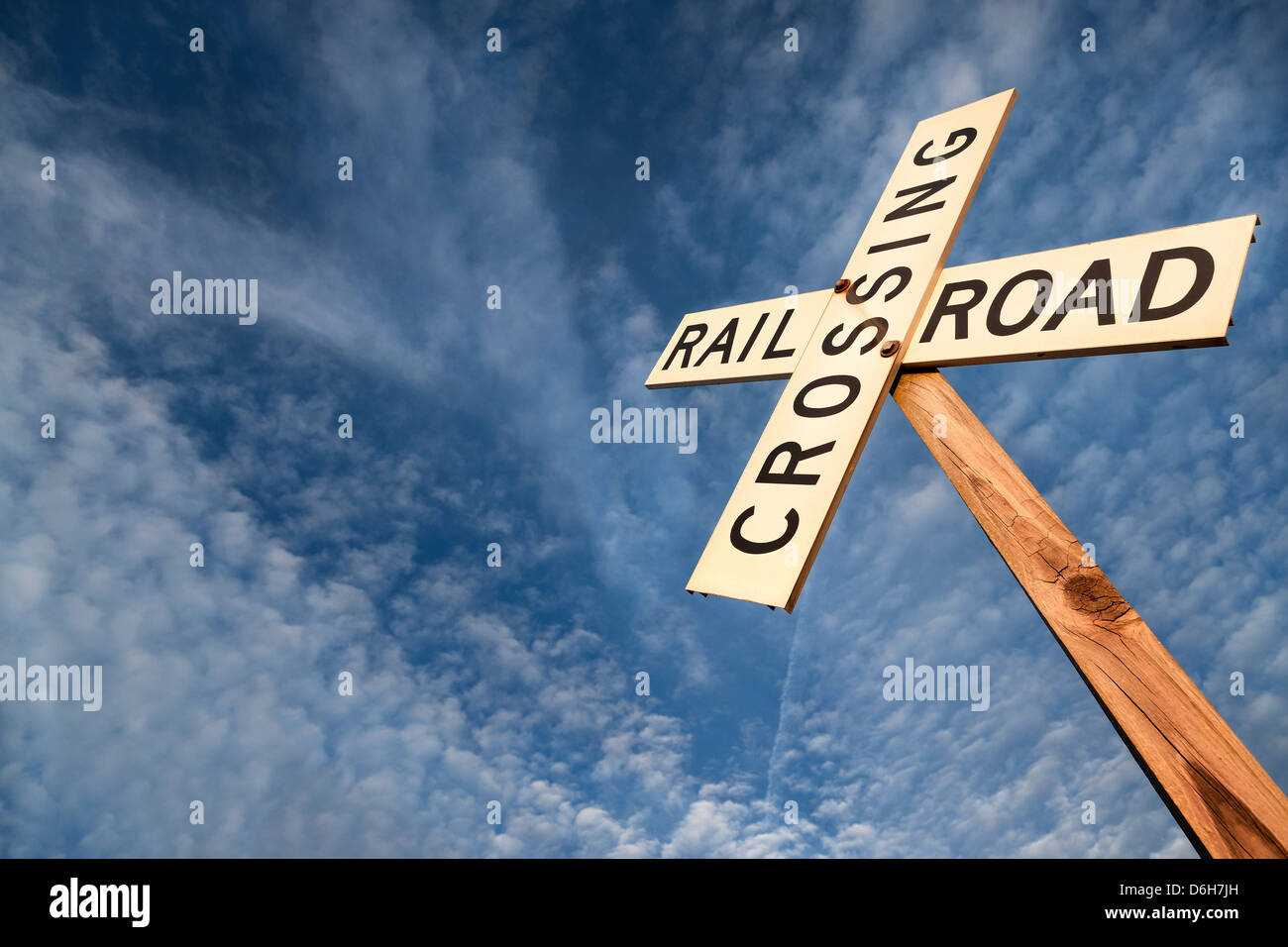 'Railroad crossing' sign under blue sky Stock Photo - Alamy