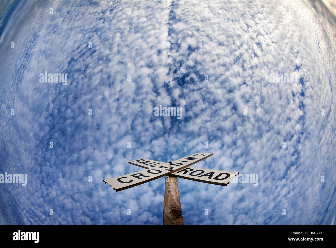 'Railroad crossing' sign under blue sky Stock Photo - Alamy
