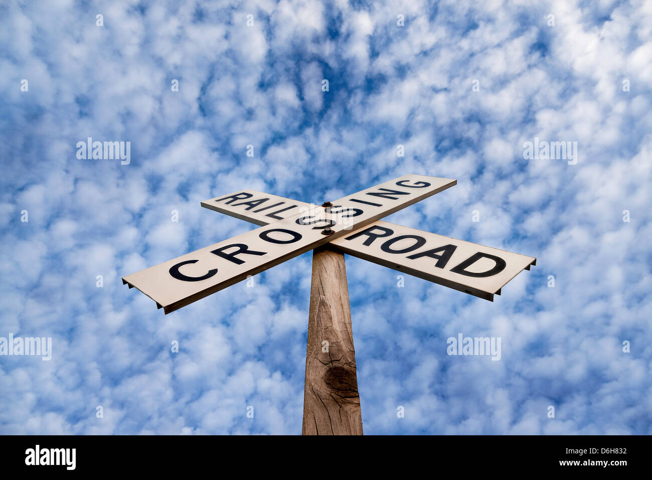 'Railroad crossing' sign under blue sky Stock Photo - Alamy