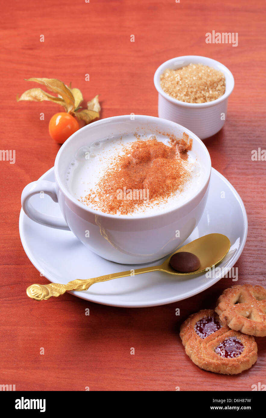 Cup of hot milk with brown sugar and cookies Stock Photo - Alamy