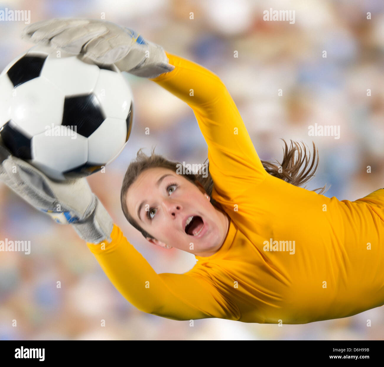 Soccer player catching ball in air Stock Photo - Alamy